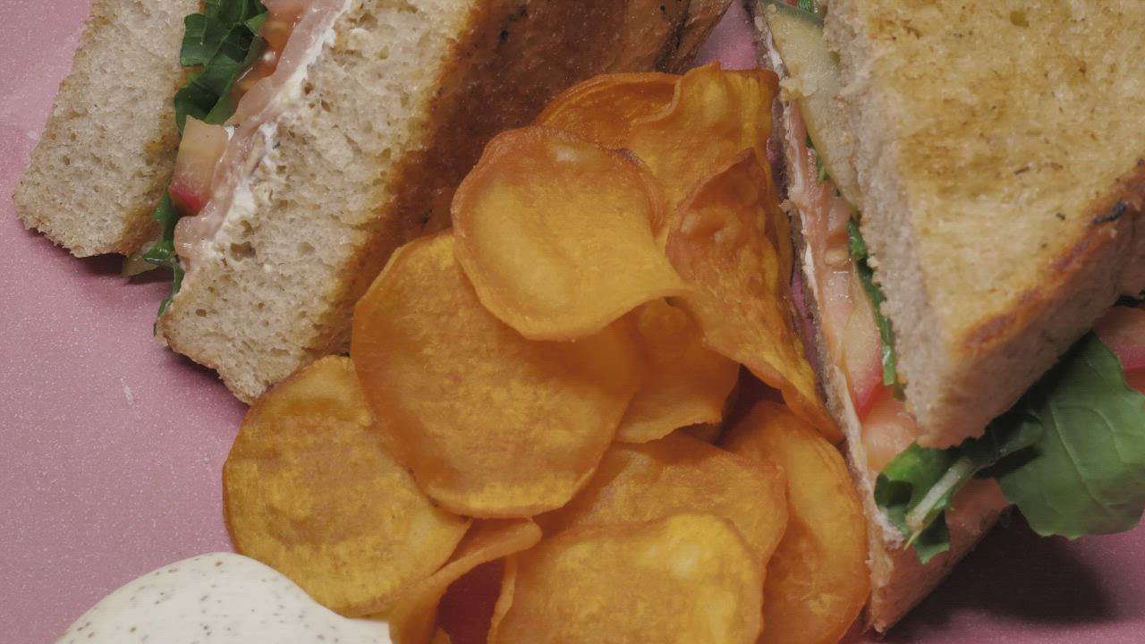 Potato chips arrangement and a sandwich split in two - Free Stock Video