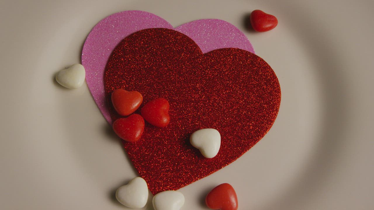 Shiny paper heart shapes and candy - Free Stock Video