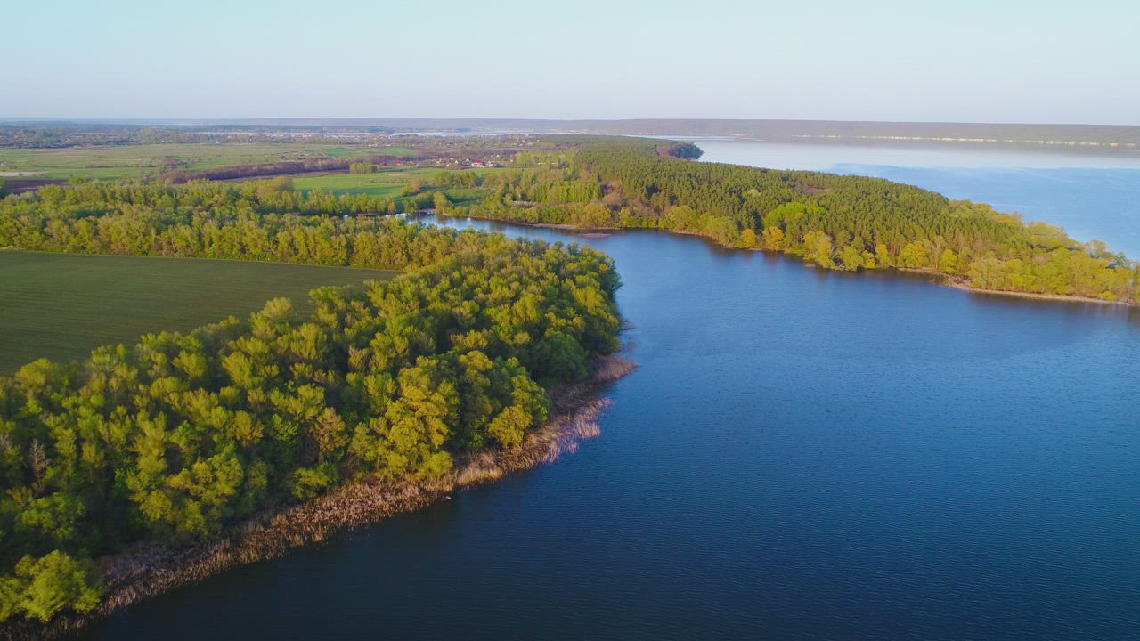River near farm fields, aerial shot - Free Stock Video