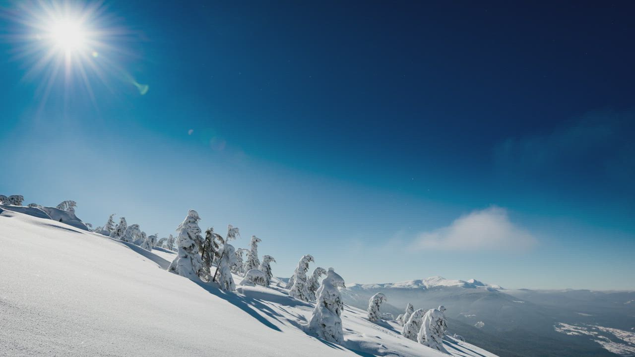 Very snowy mountain on a clear sunny day - Free Stock Video