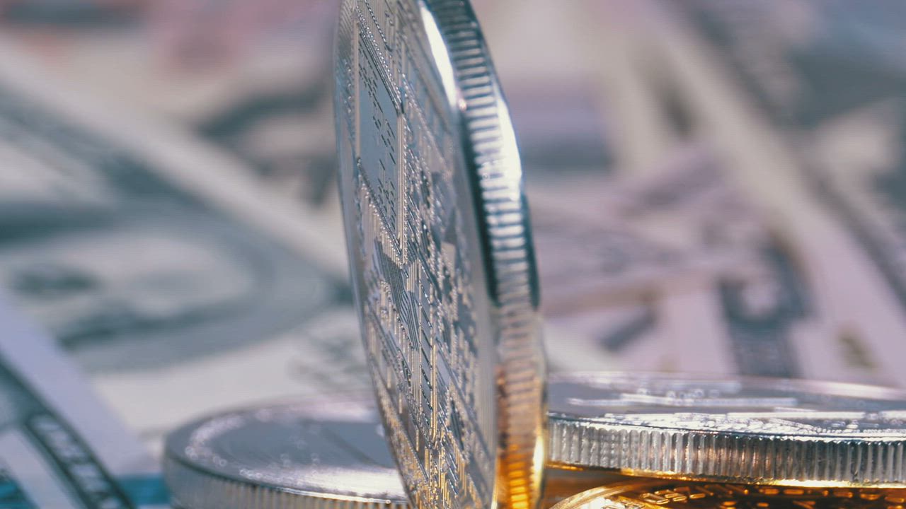 Silver Bitcoin rotating of a dollar bills - Free Stock Video