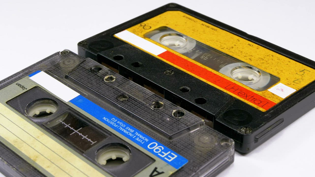 Two vintage audio cassettes rotating - Free Stock Video
