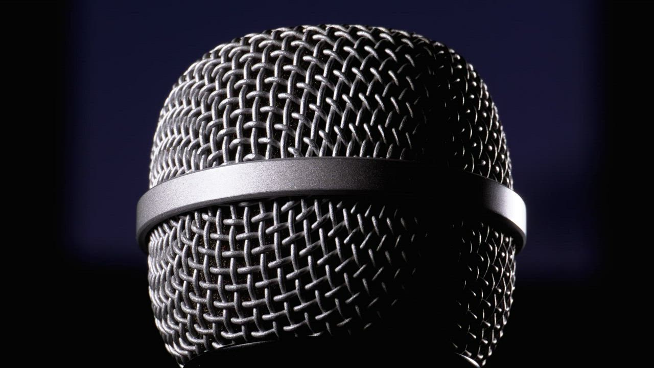 Microphone rotating on a black background - Free Stock Video