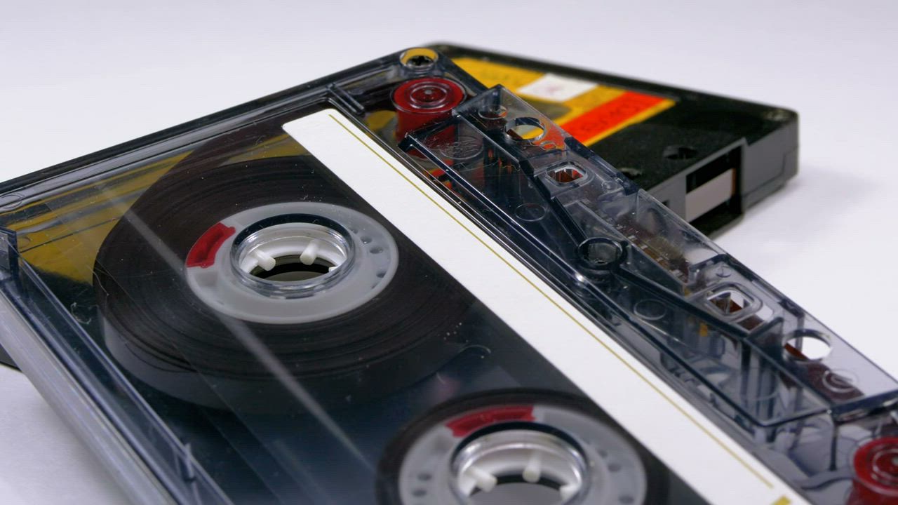 Close up of two vintage audio cassettes rotating - Free Stock Video