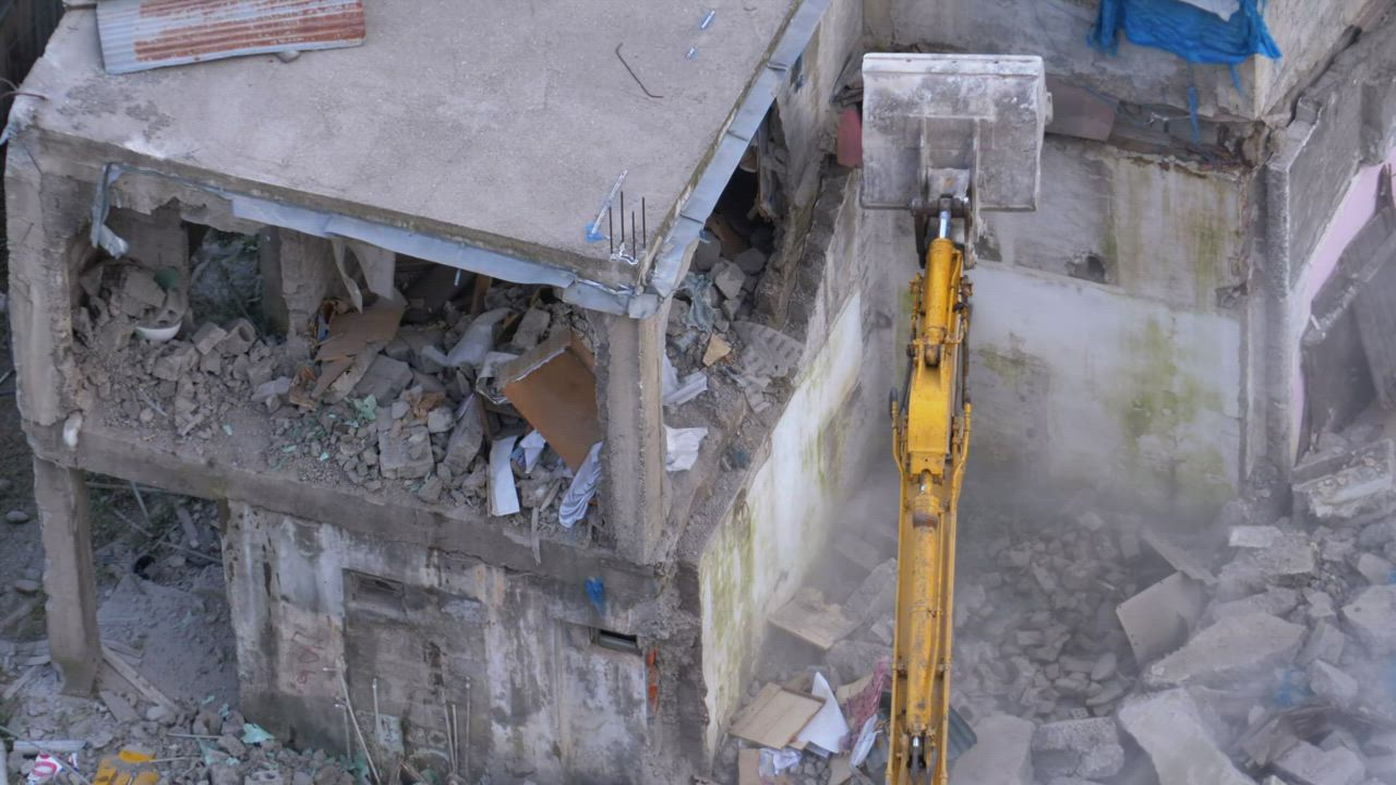 Bulldozer destroying a concrete building - Free Stock Video