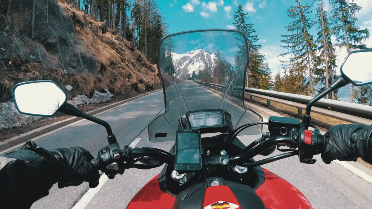 View of a motorcycle driving in the mountains - Free Stock Video