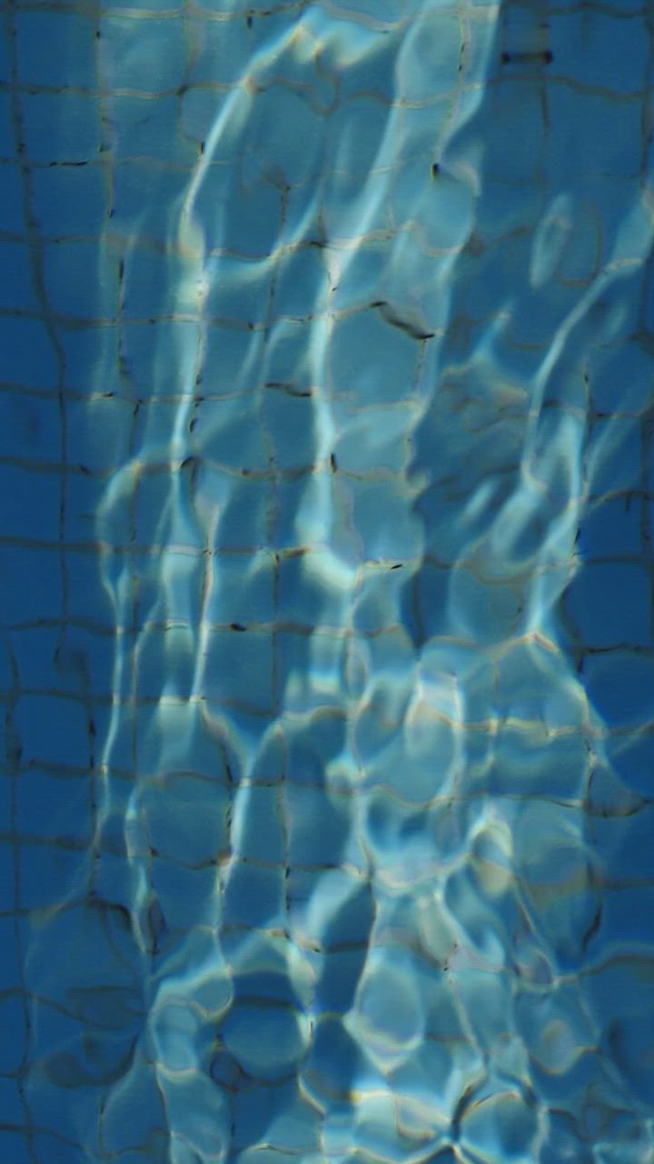 Blue pool with water making waves - Free Stock Video