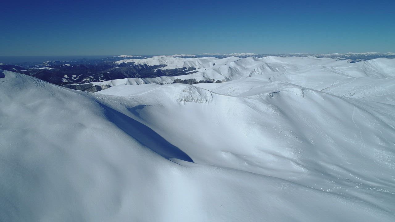 Smooth texture of snow over mountains - Free Stock Video