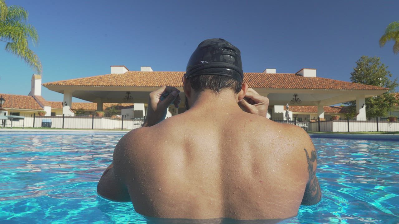 Swimmer in the pool seen from behind - Free Stock Video