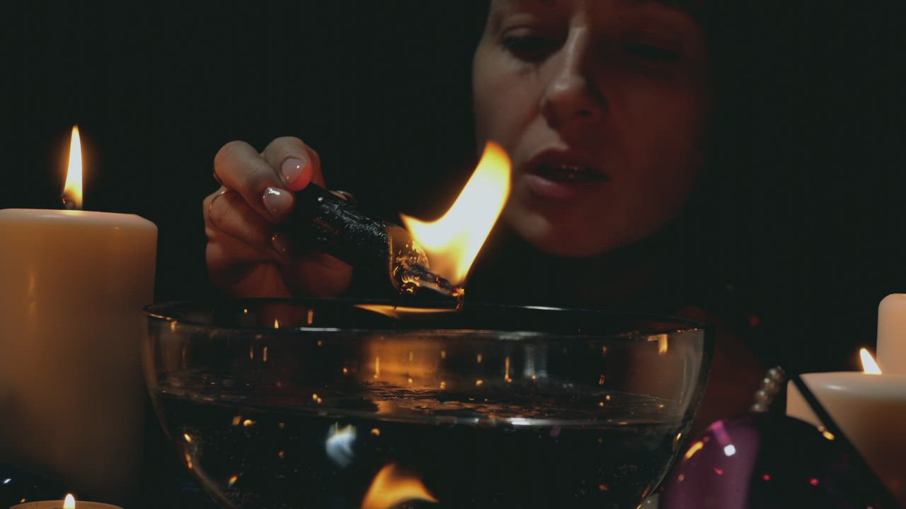 Woman doing a ritual with a candle - Free Stock Video
