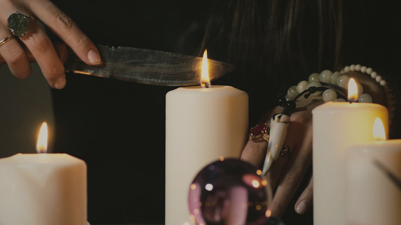 Woman doing the magic ritual with a candle - Free Stock Video