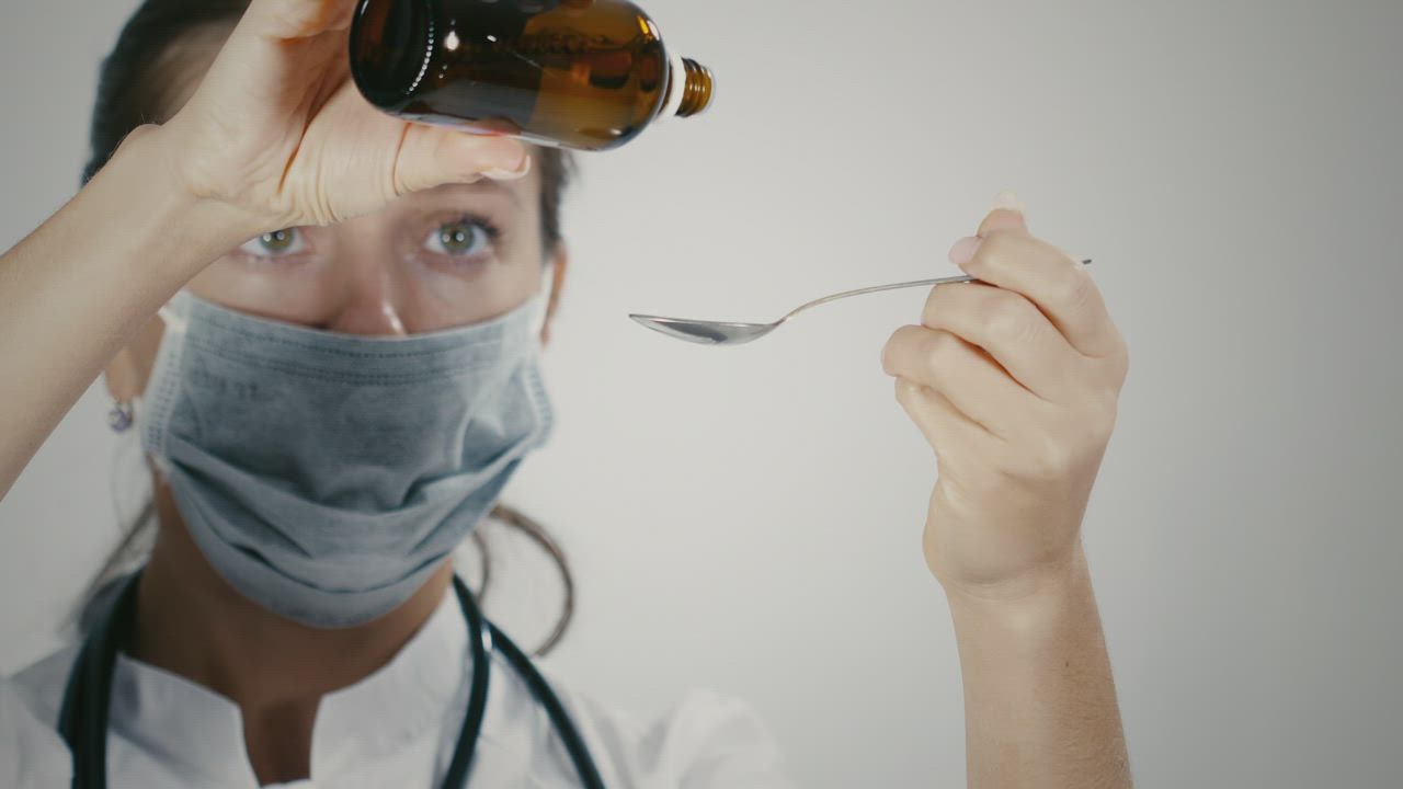 Dripping medicine into a spoon - Free Stock Video
