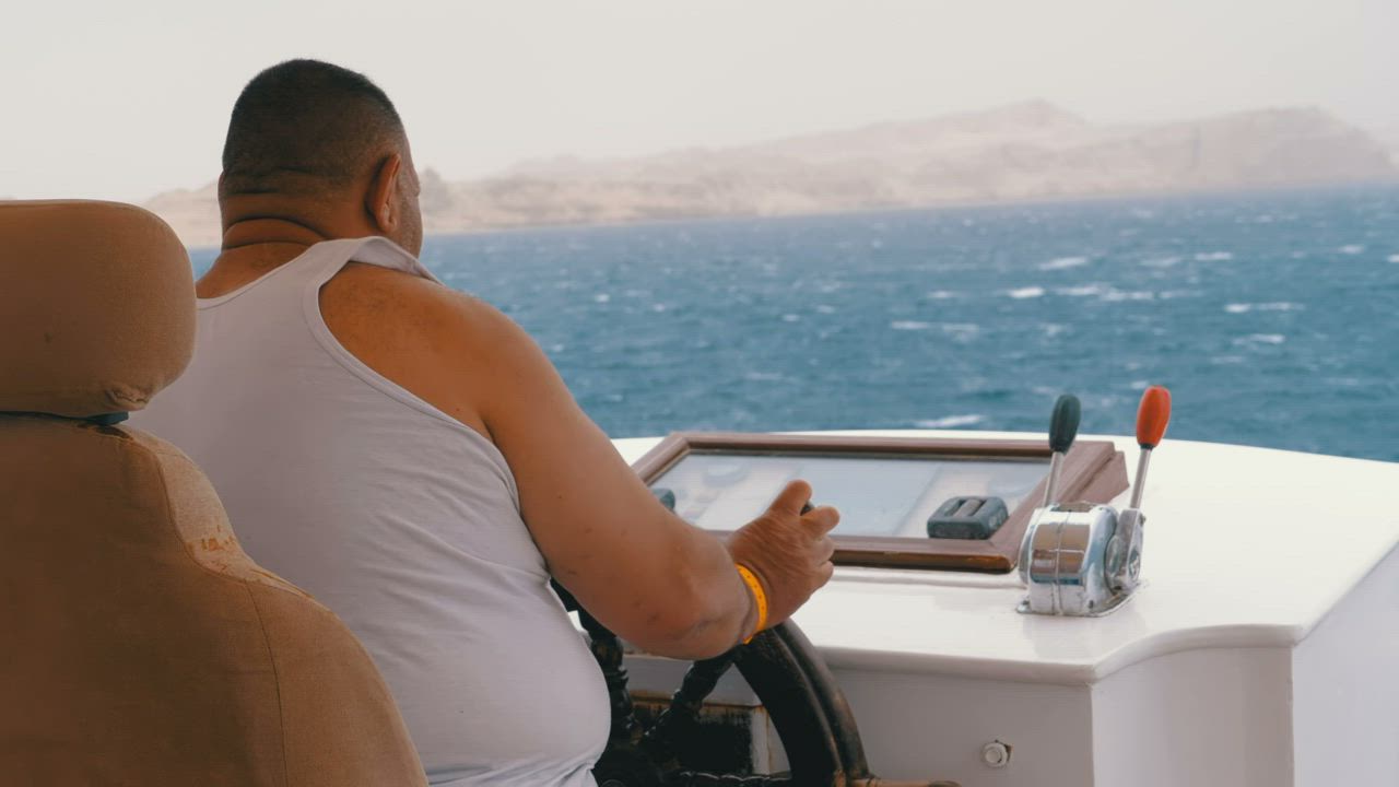 Captain sailing a yatch in the sea - Free Stock Video