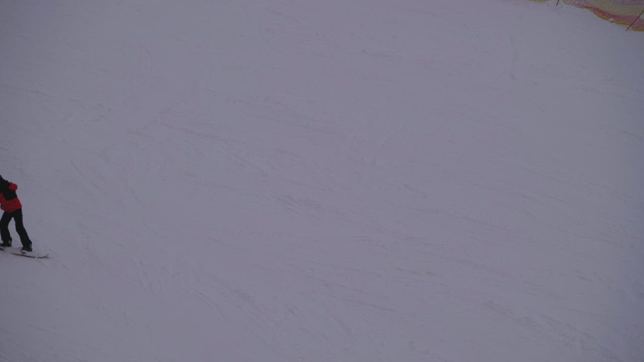 Practicing snowboarding in the mountain - Free Stock Video