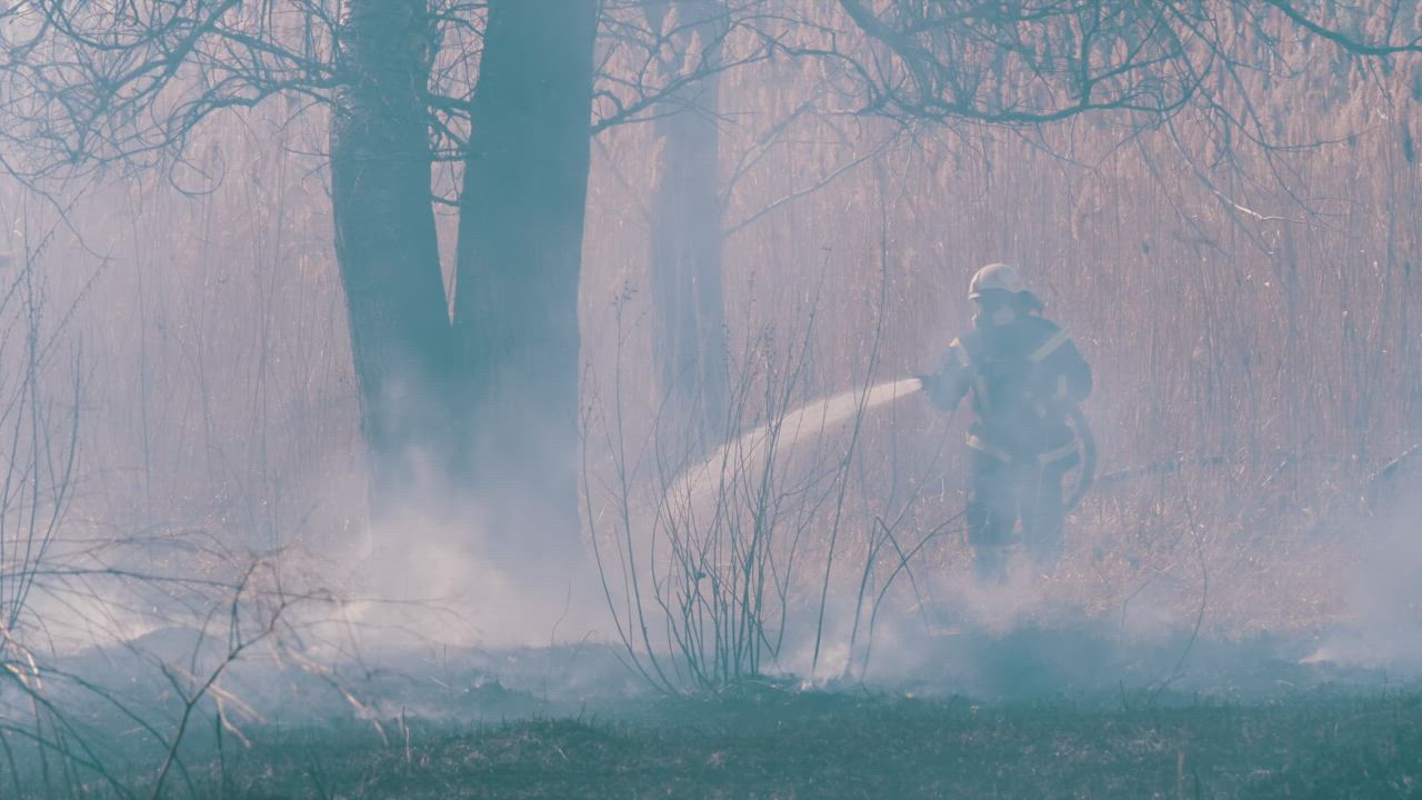 Firefighters throwing water at fire - Free Stock Video