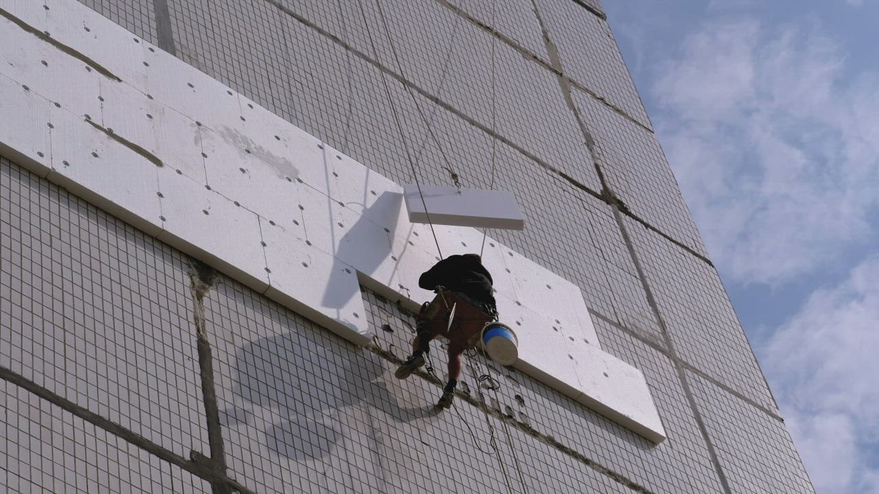 Worker suspended with ropes on a building - Free Stock Video