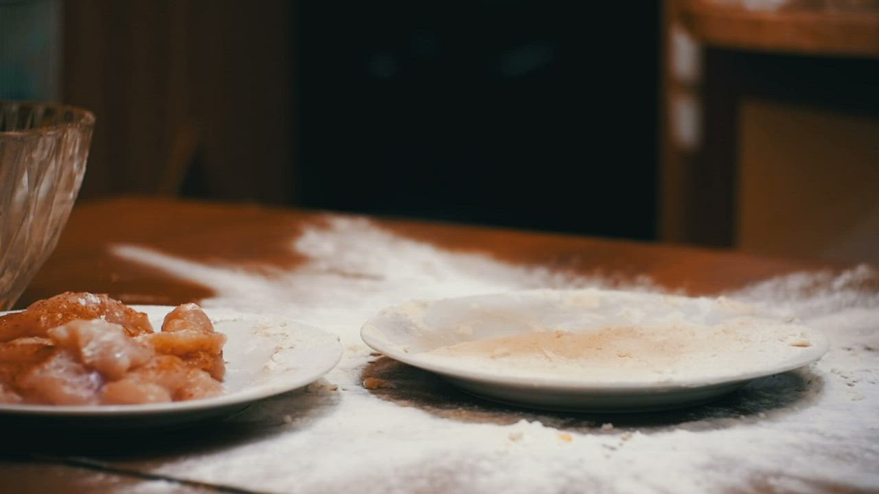 Straining flour to prepare meat - Free Stock Video