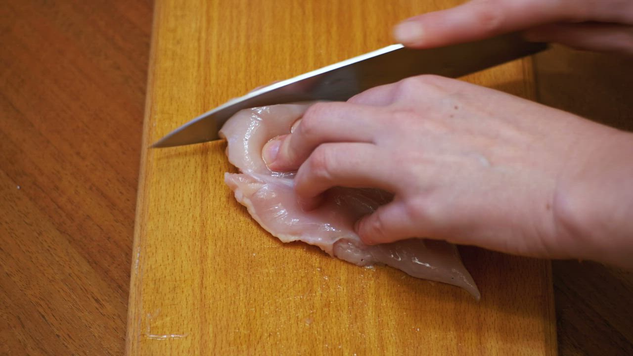 Slicing raw chicken meat - Free Stock Video