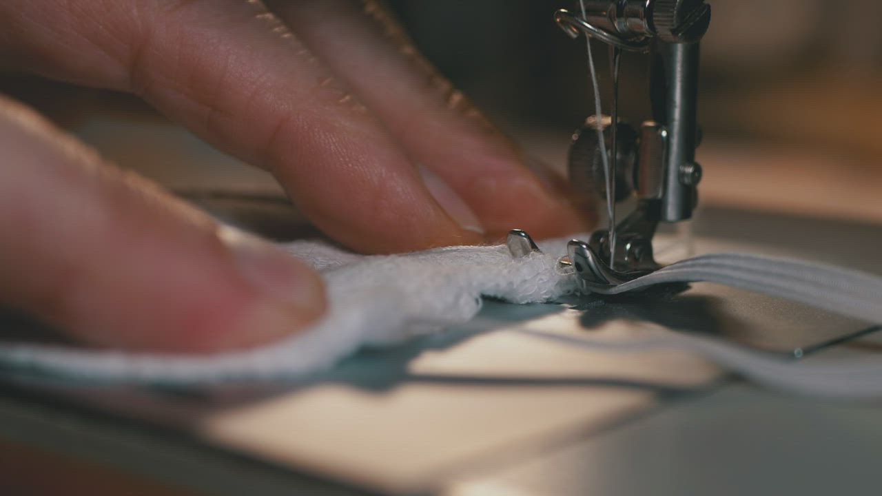 Close up of a person sewing a face mask - Free Stock Video