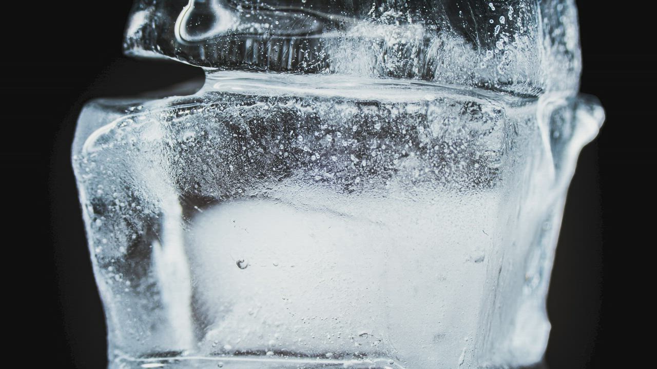 Ice cubes thawing on black background - Free Stock Video