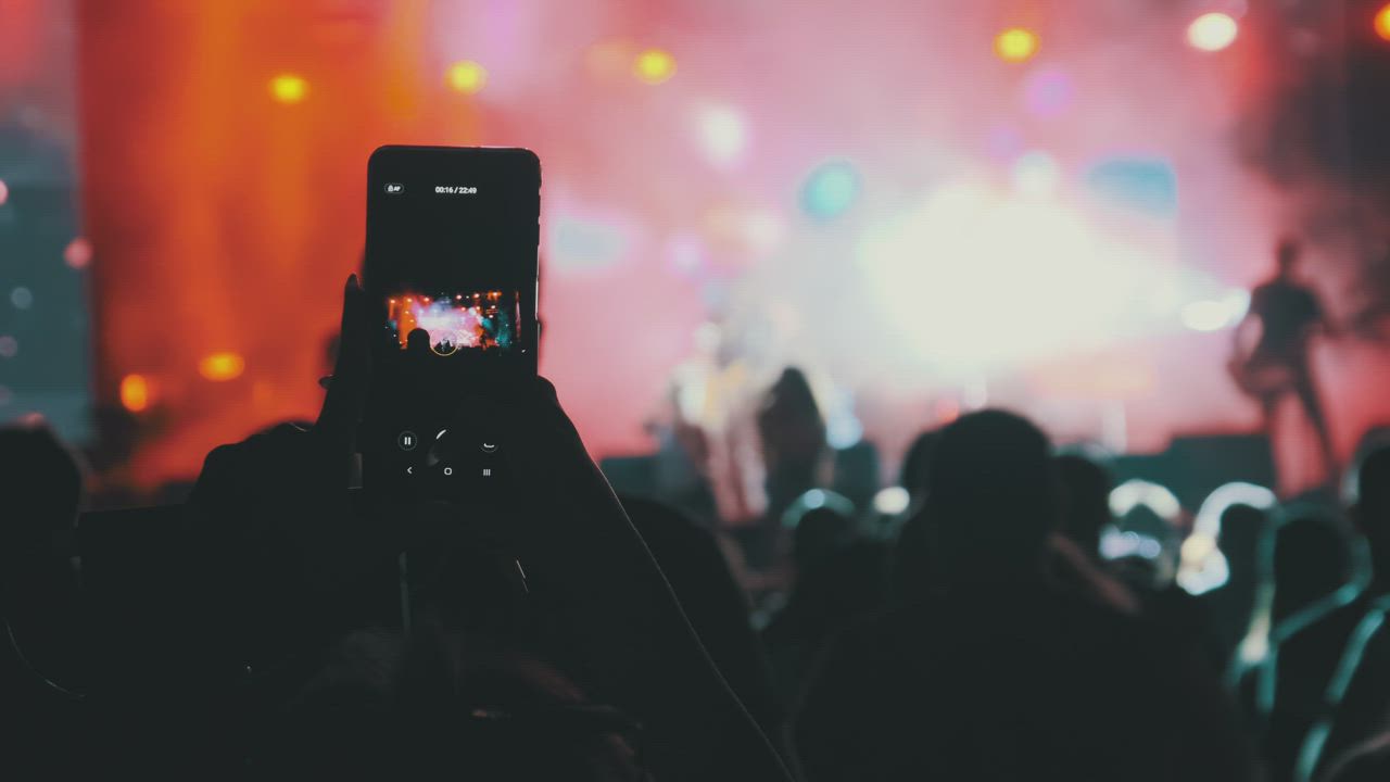 Person recording a concert with his cell phone - Free Stock Video