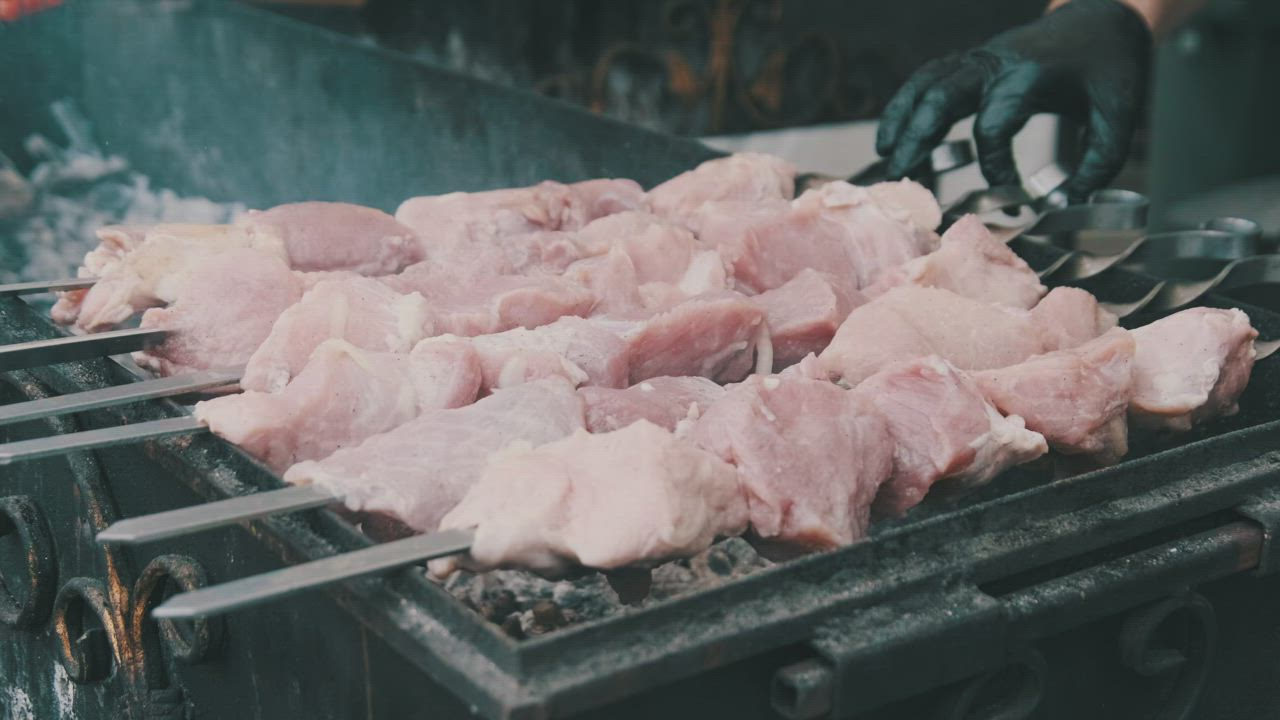 Chef cooking meat skewers, static shot - Free Stock Video