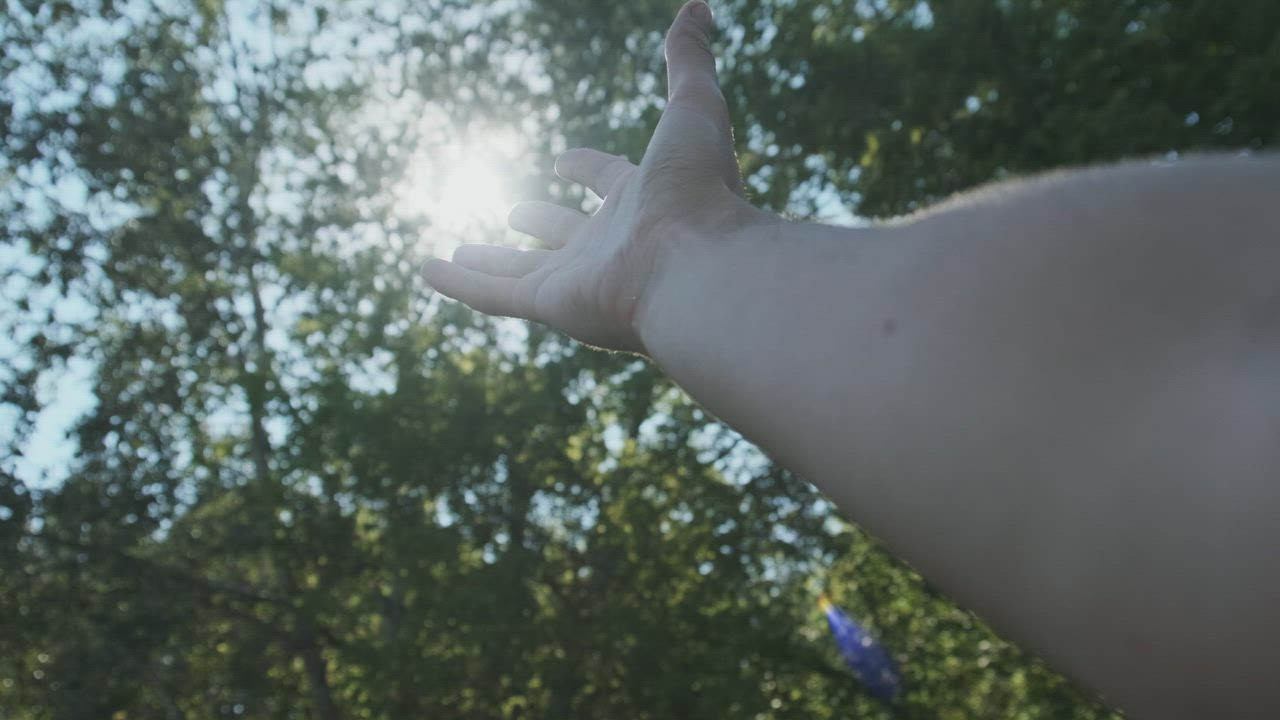 POV of a person's hand touching the sun - Free Stock Video