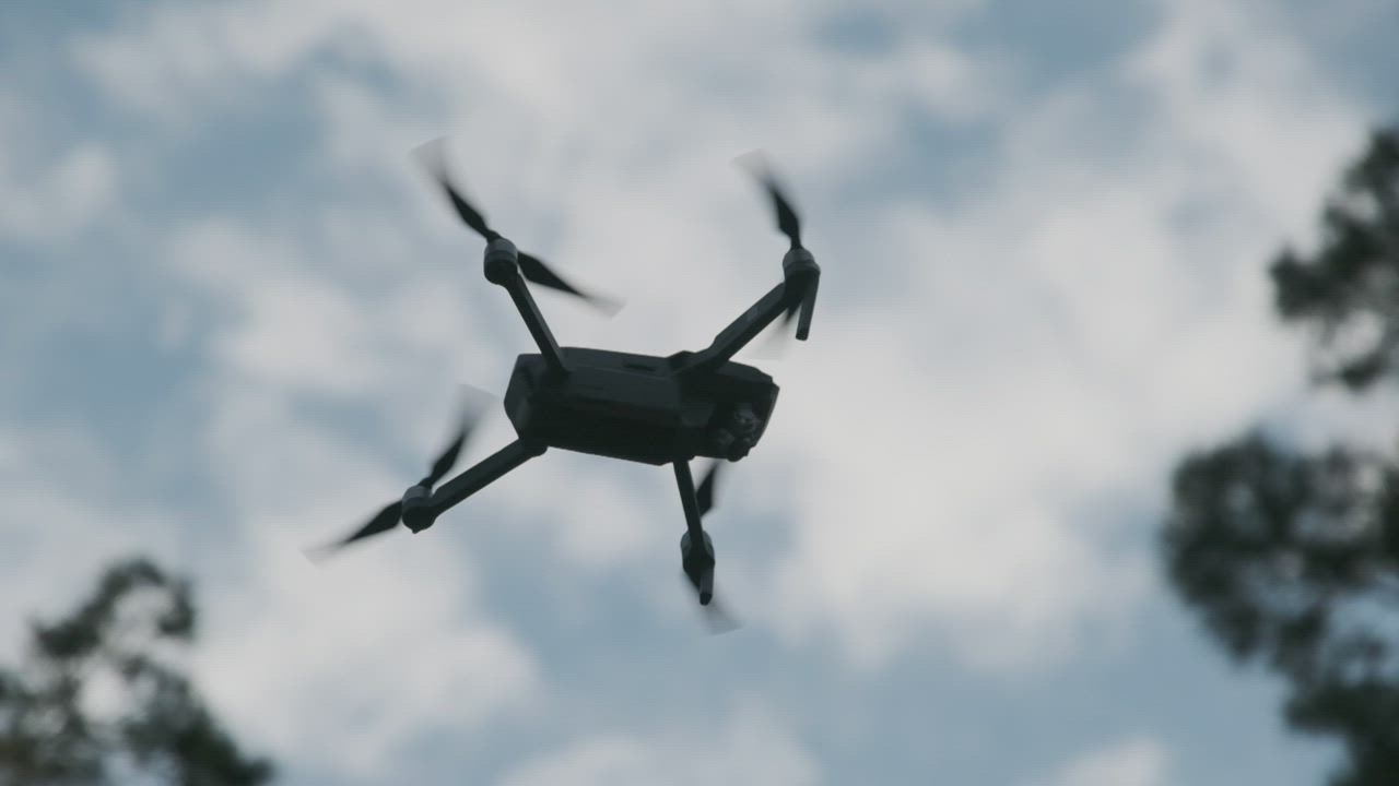 Low view of a drone flying in slow motion - Free Stock Video