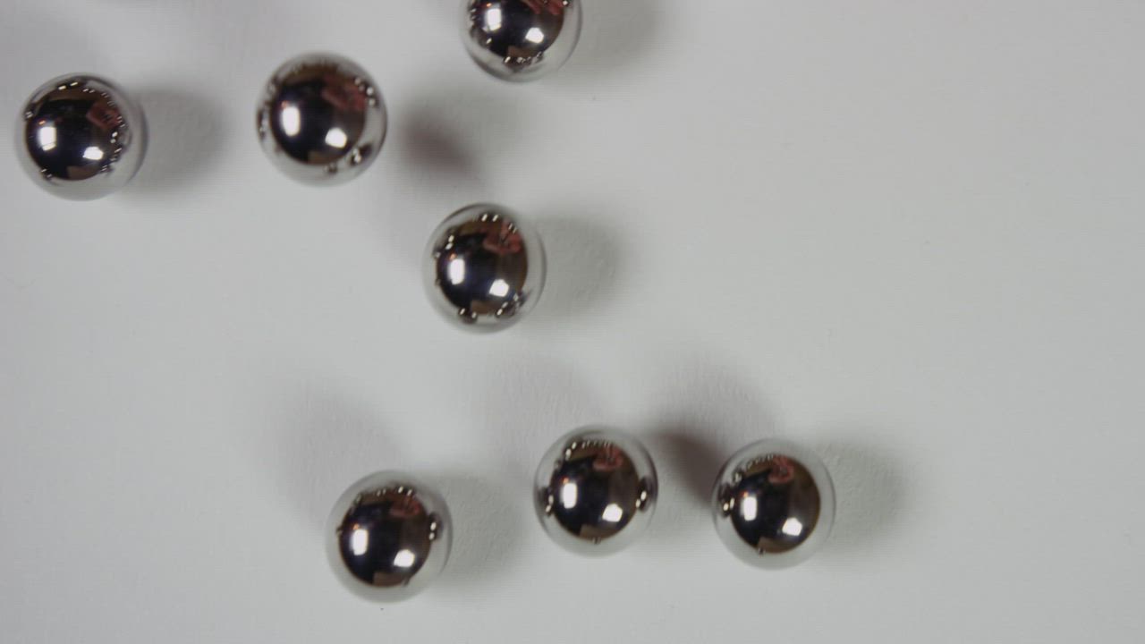Metal pellets on white surface - Free Stock Video