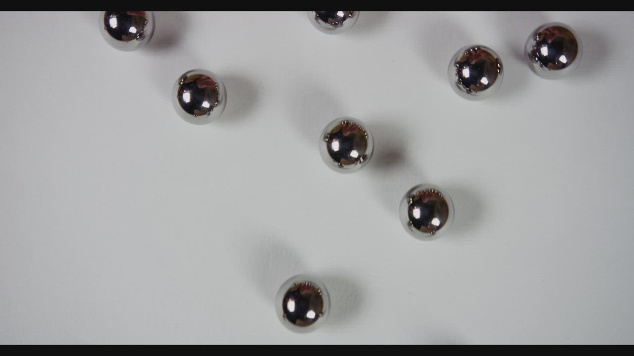 Metal pellets roll from bottom to top - Free Stock Video