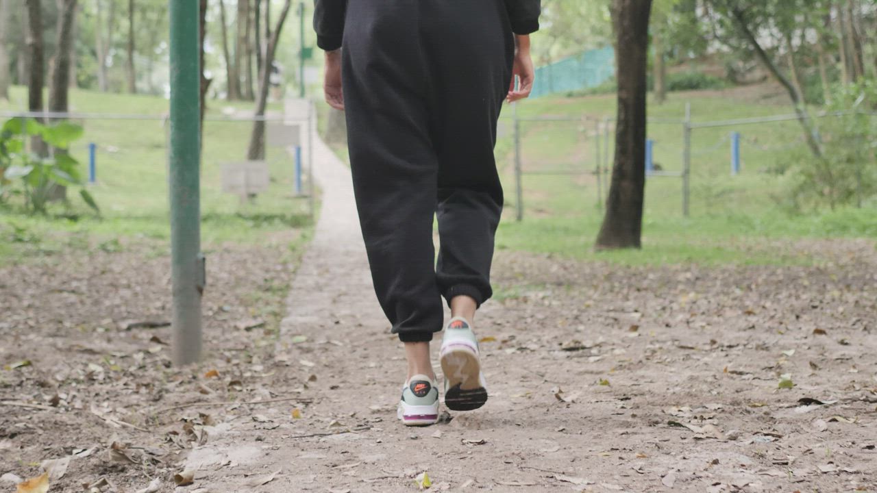 Young woman from behind walking in nature - Free Stock Video