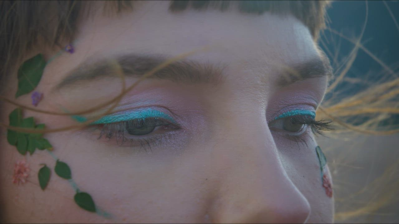 Makeup eyes of a woman with the wind blowing her hair - Free Stock Video