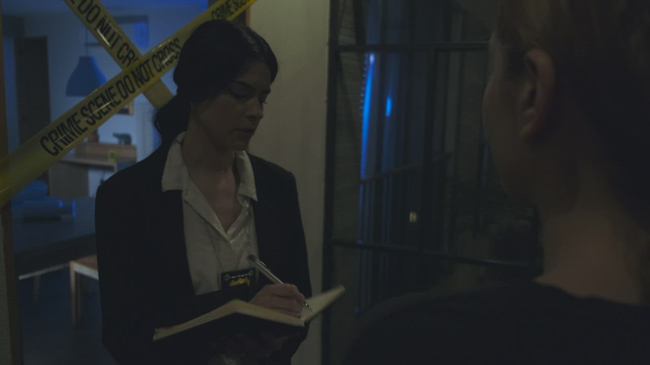 Female police officer interrogating a person at a crime scene - Free ...