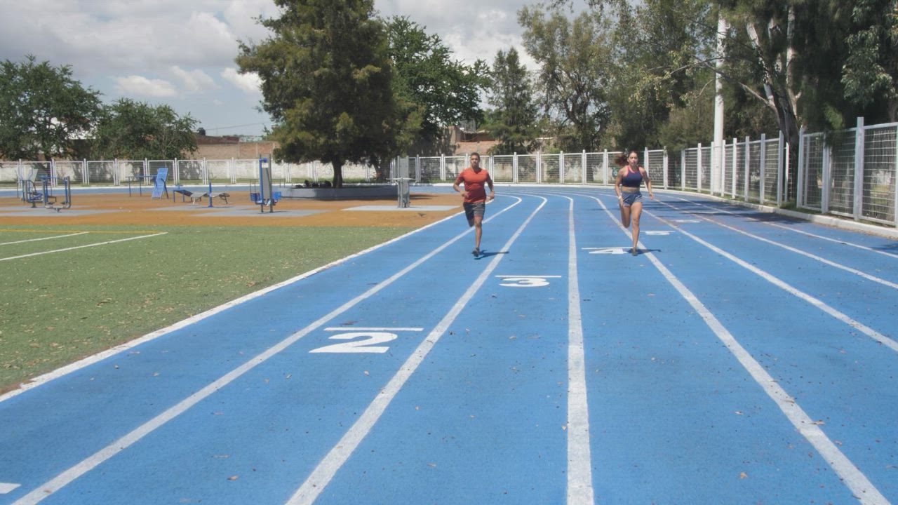 Man and woman training on a running track - Free Stock Video
