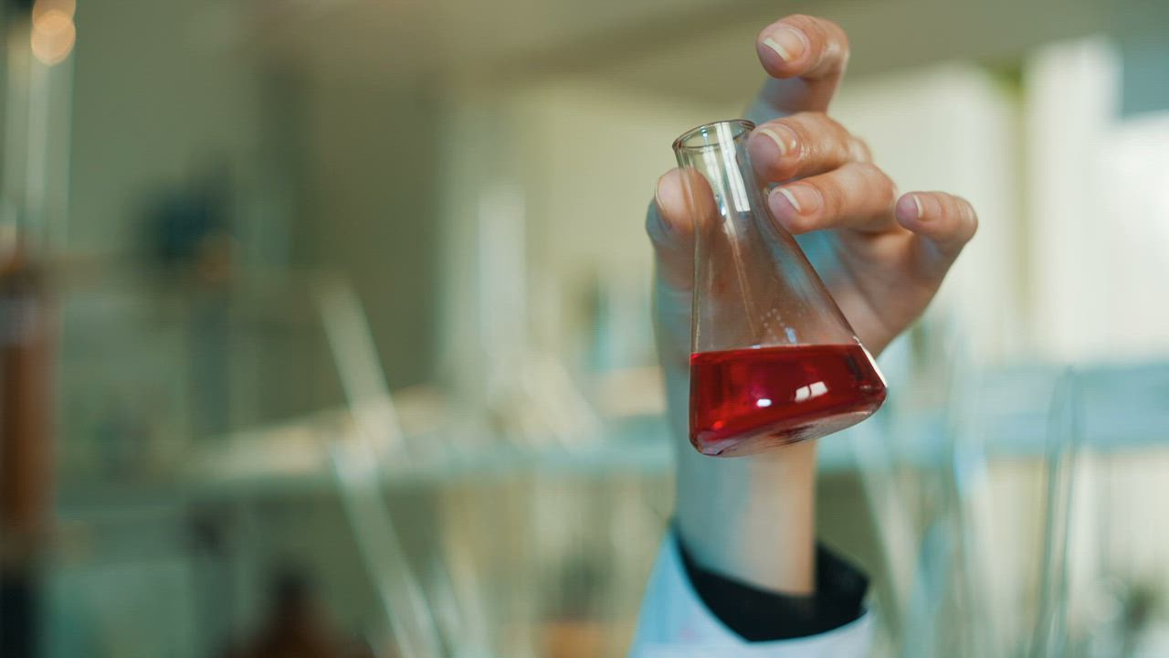 Scientist shaking a conical flask in the laboratory - Free Stock Video