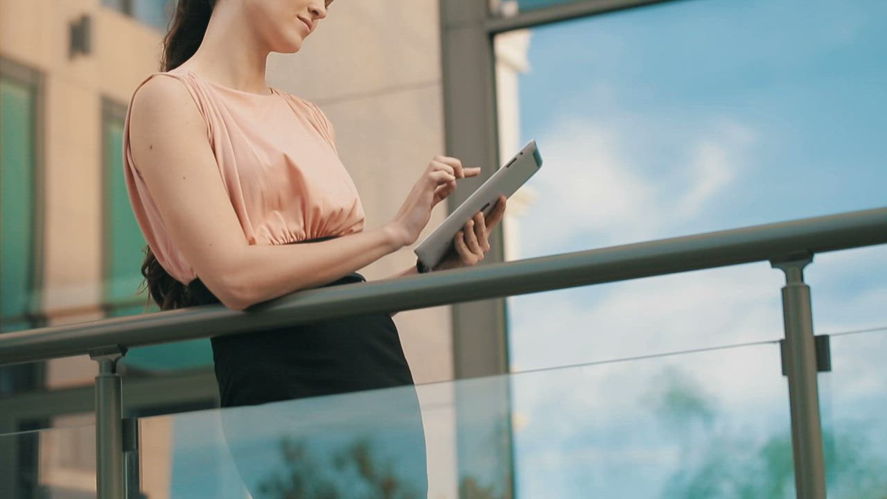 Woman working on her tablet outside the office - Free Stock Video