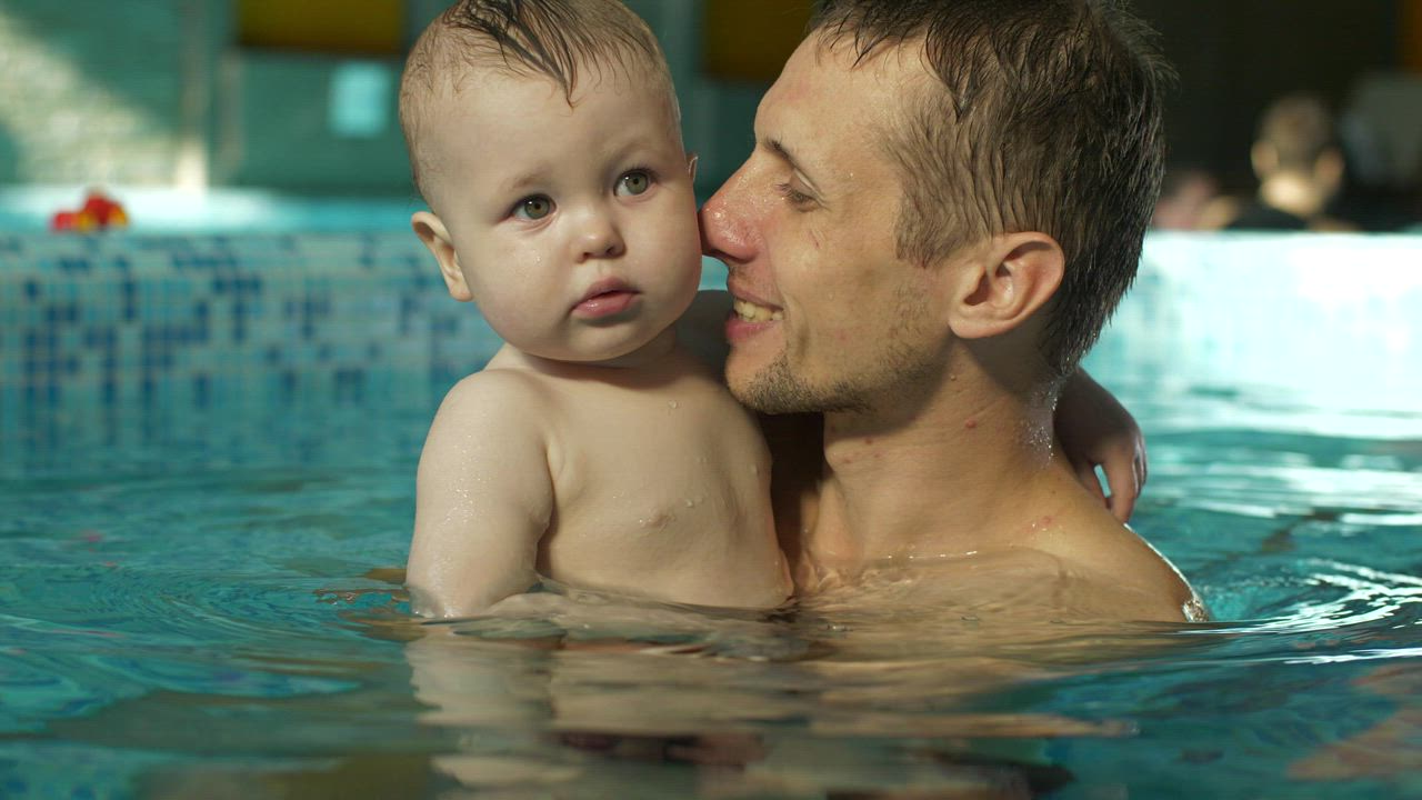 Father hugging his son in the pool - Free Stock Video