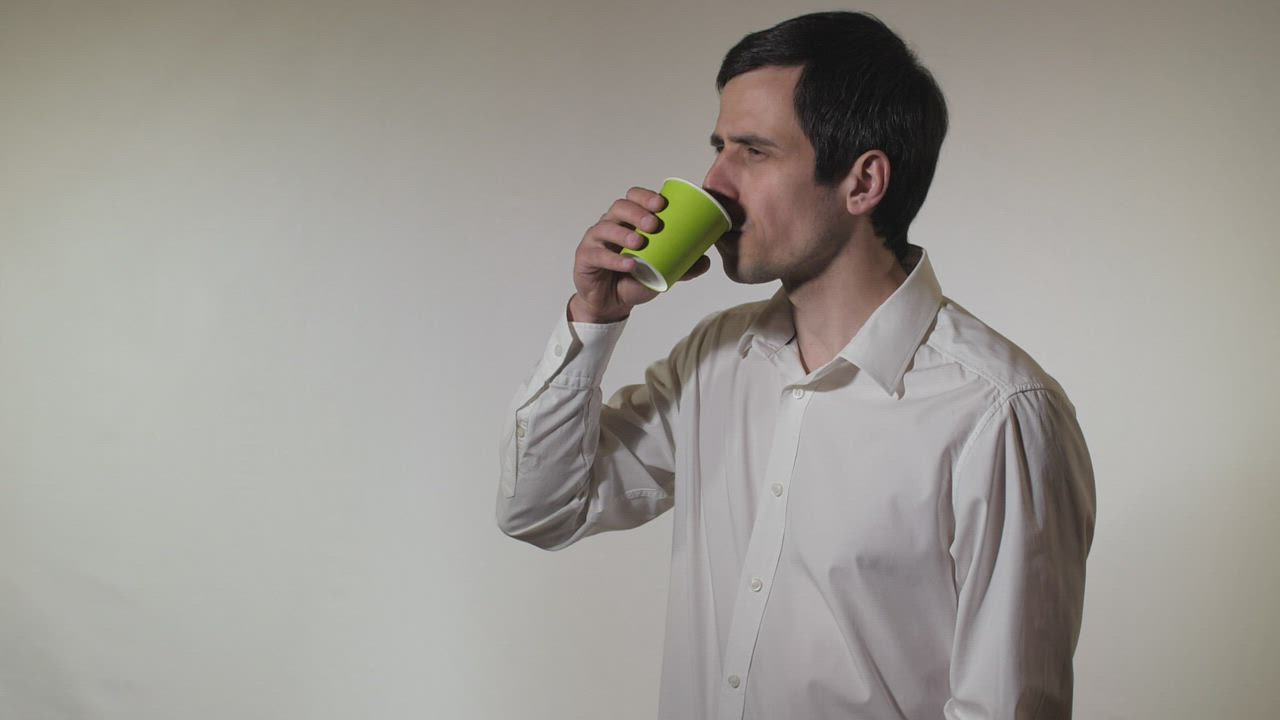 Man spills his drink while drinking it - Free Stock Video