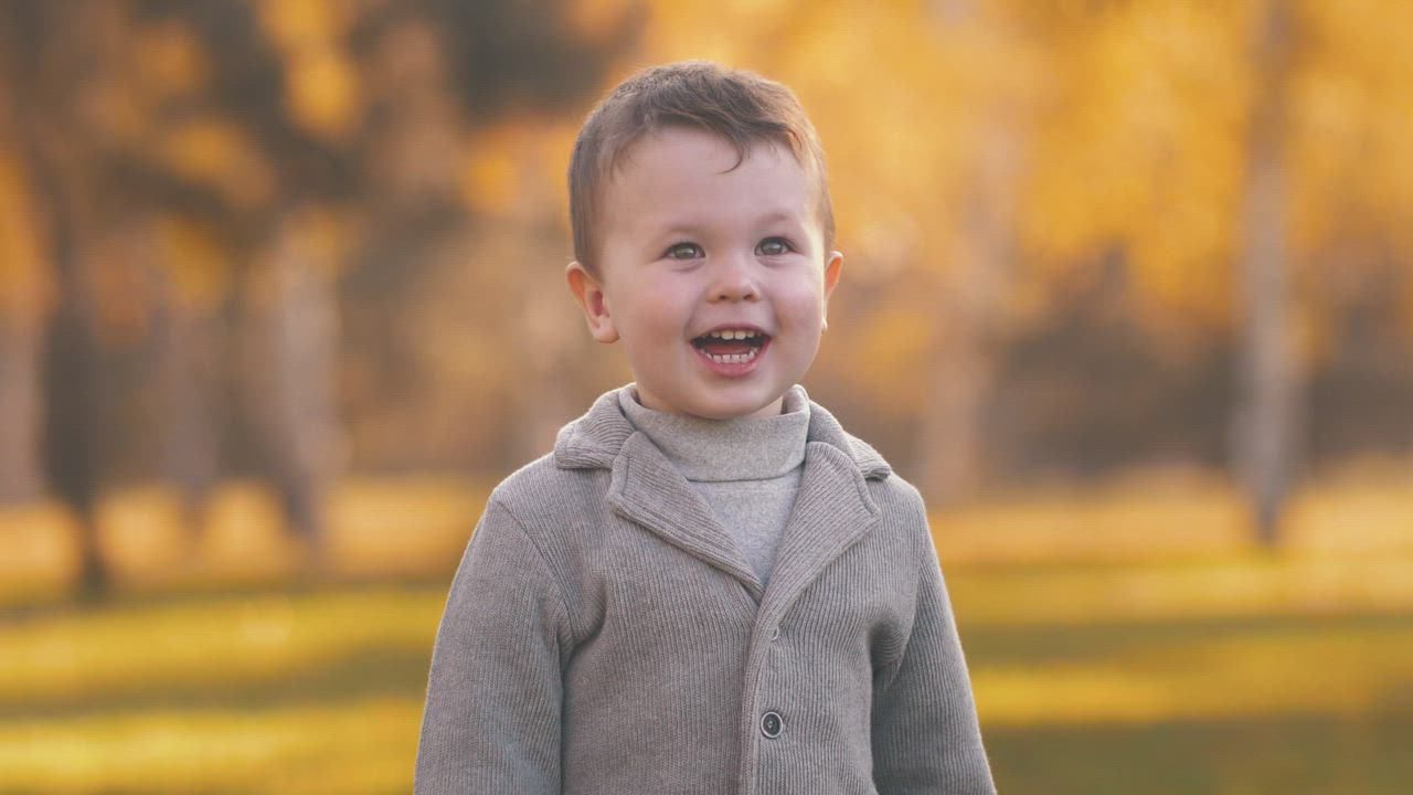 Very cheerful child smiling in the autumn park - Free Stock Video