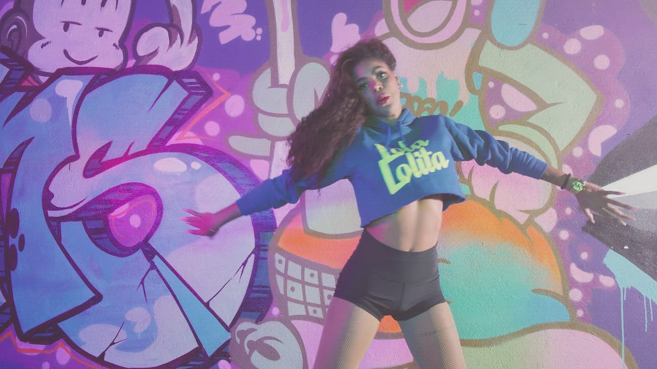 Urban dancer girl in front of a wall with graffiti - Free Stock Video