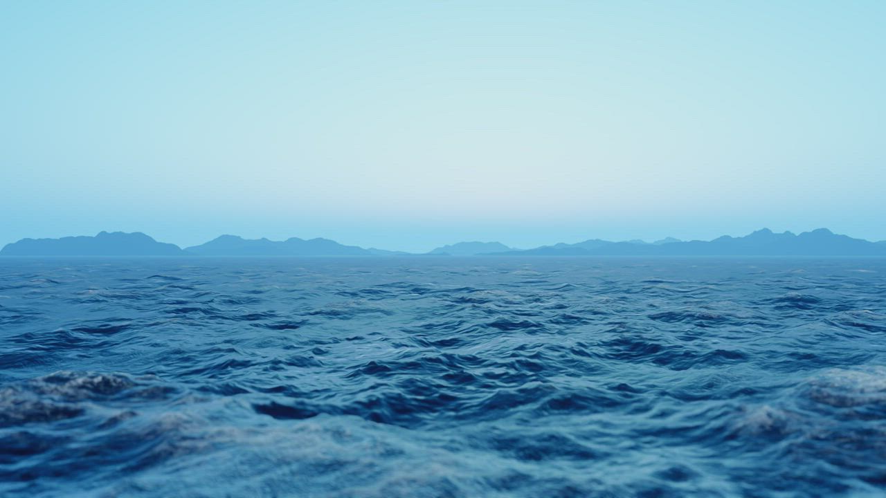 Choppy ocean waves with mountains in the background - Free Stock Video