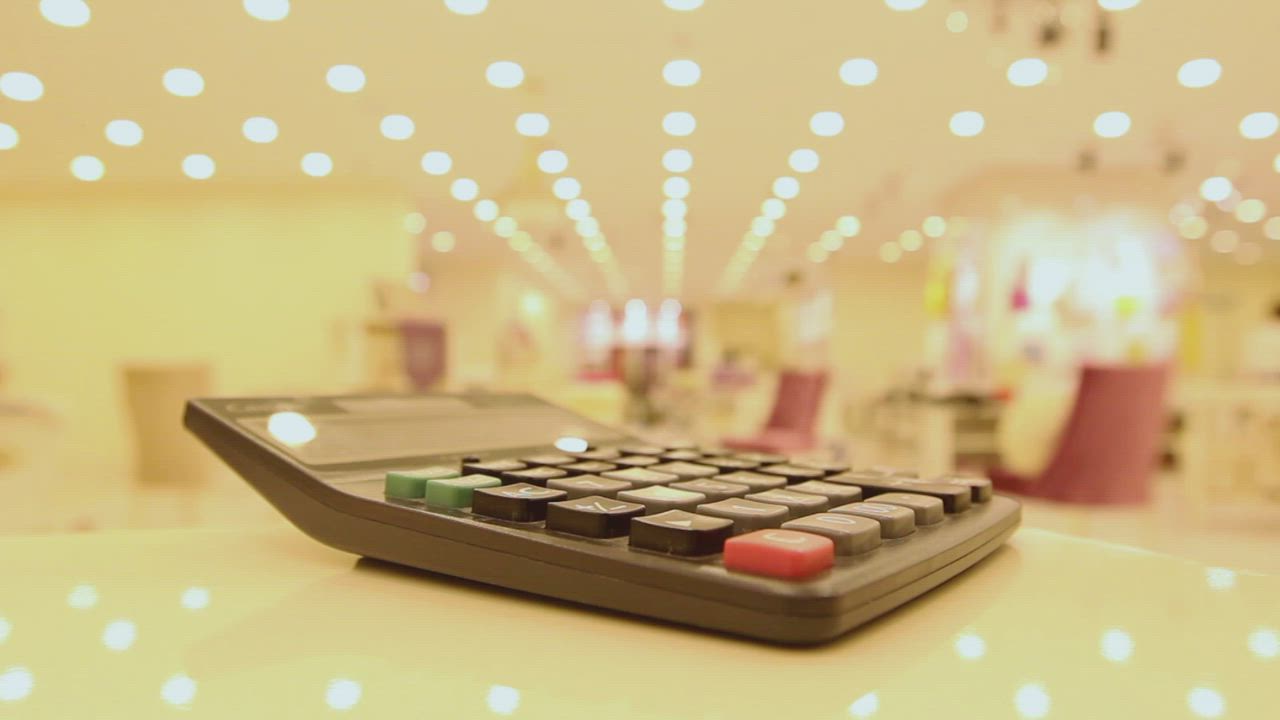Typing in a calculator in a department store - Free Stock Video