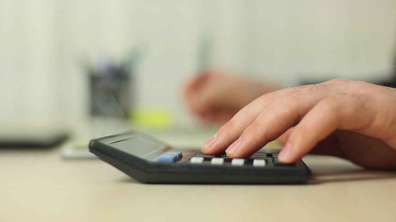 Person doing calculations with a calculator - Free Stock Video