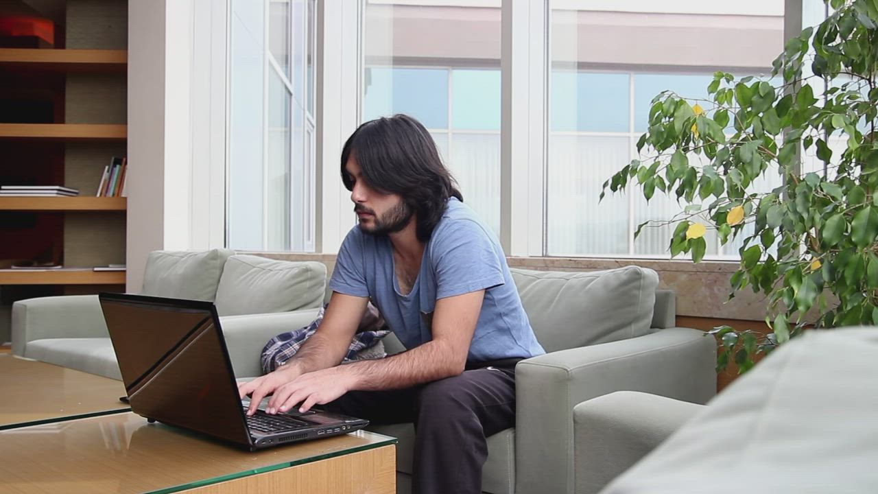 Man working on a computer in a room - Free Stock Video