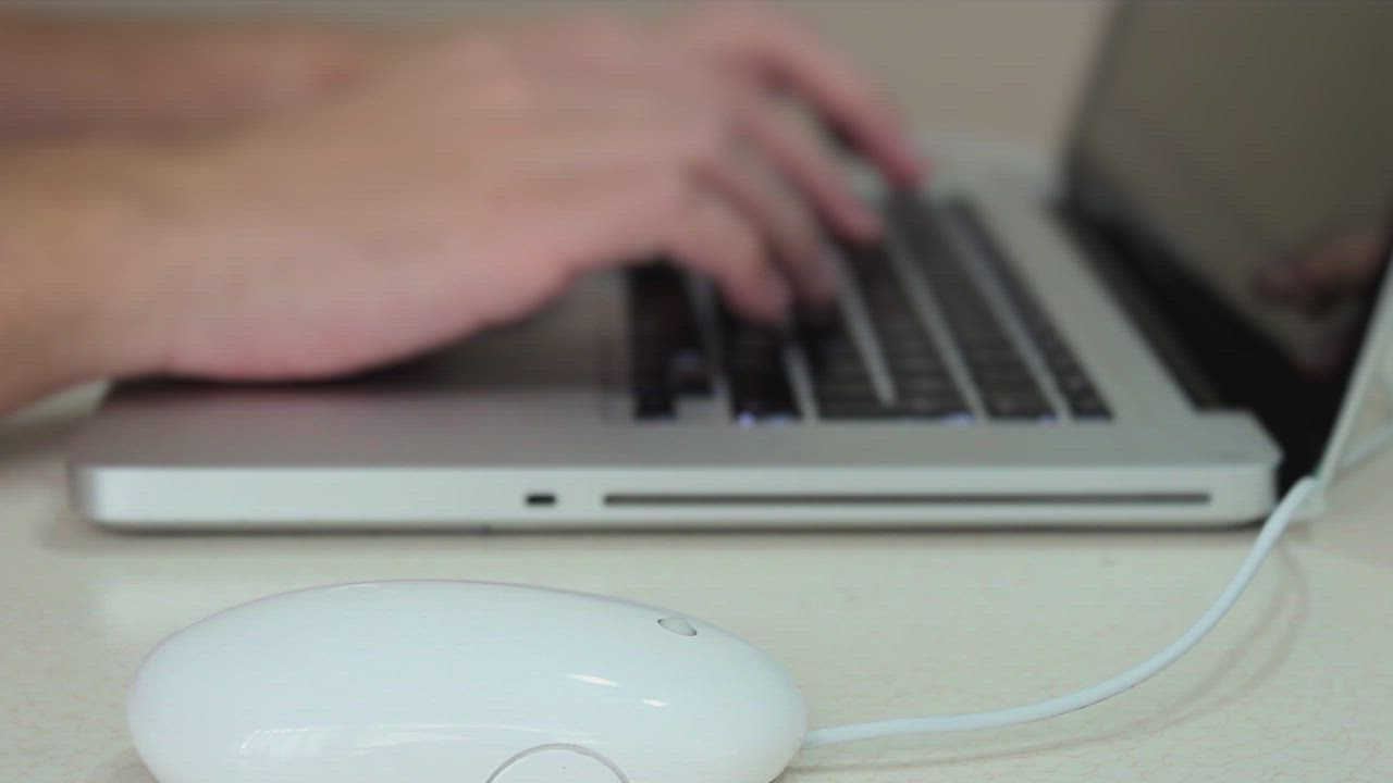Hands of a man using a laptop deftly - Free Stock Video