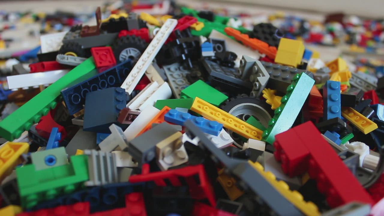Selecting pieces of lego in a pile - Free Stock Video