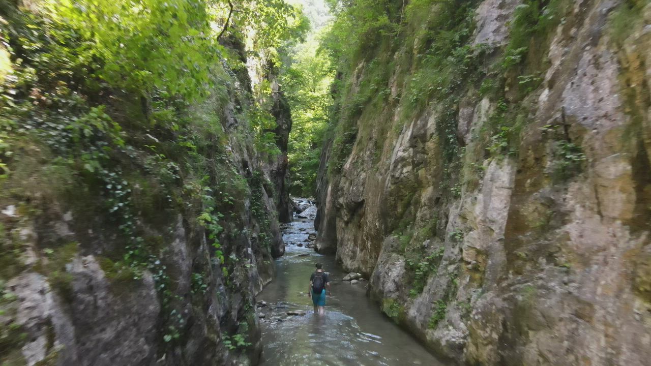 Drone tour above a river between two mountains - Free Stock Video