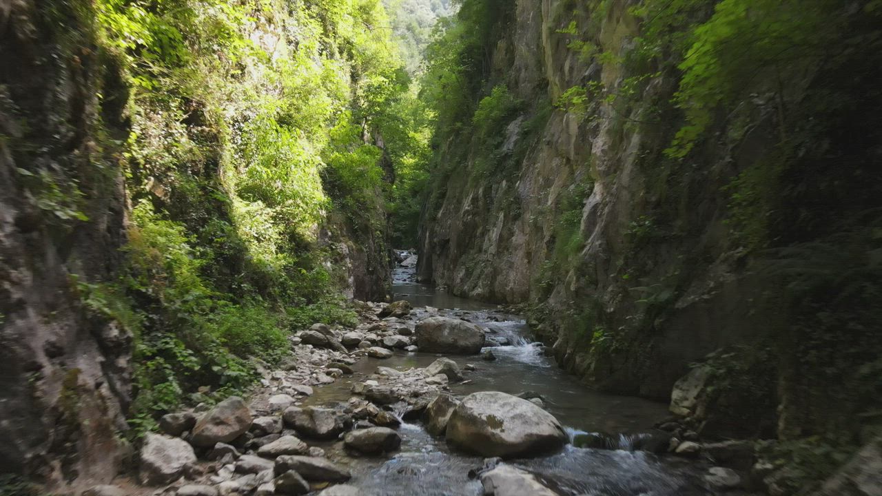 Travel between two mountains above a river - Free Stock Video