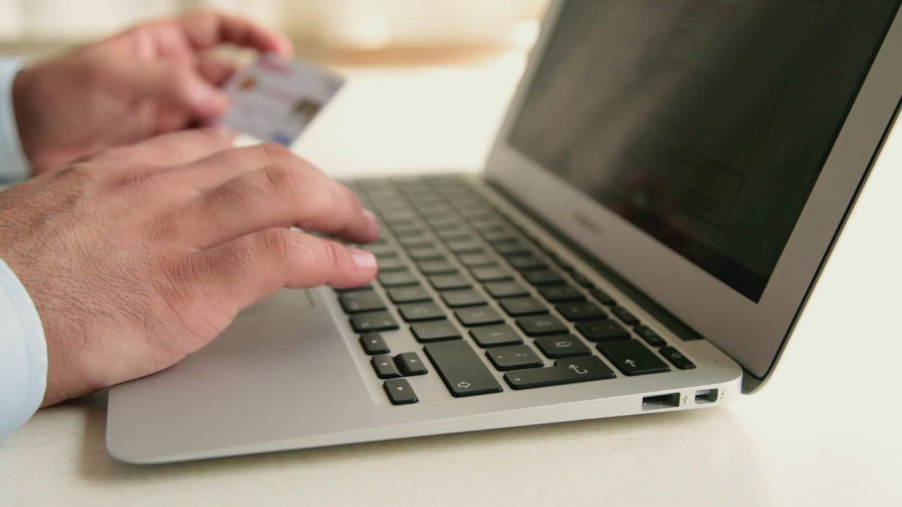 Typing a credit card data into a computer - Free Stock Video