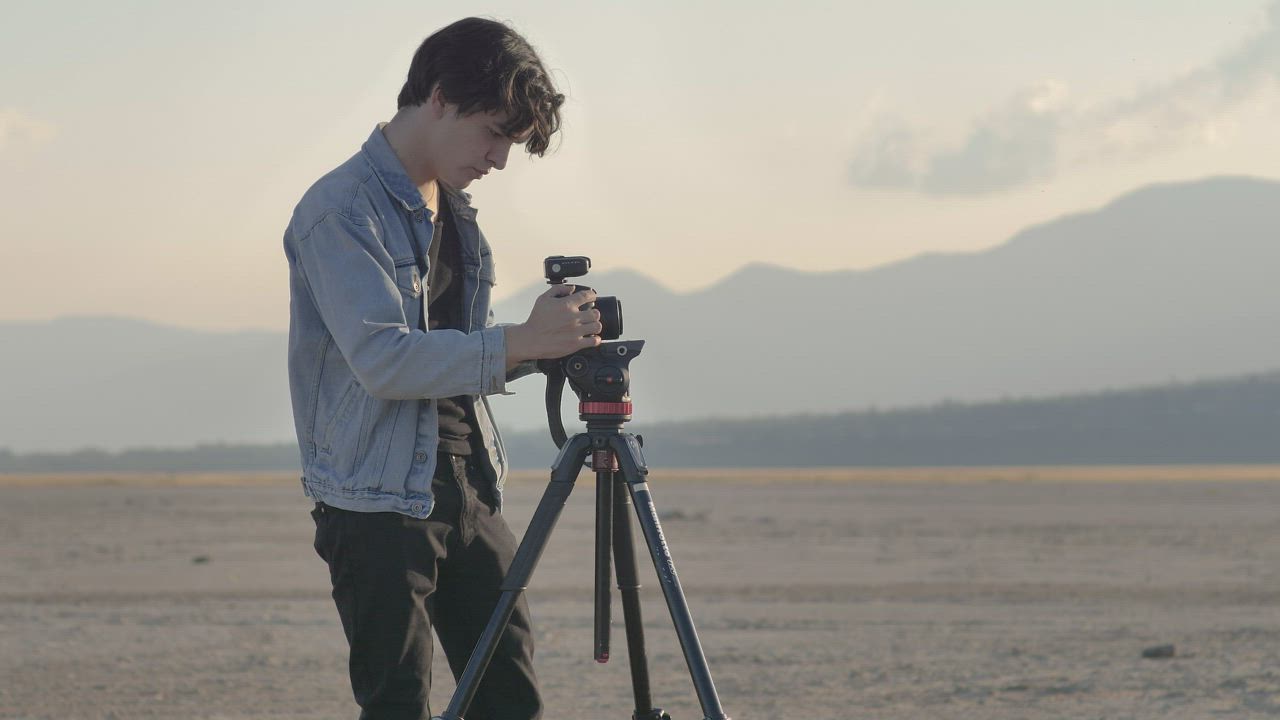 Man taking photos in a desert - Free Stock Video